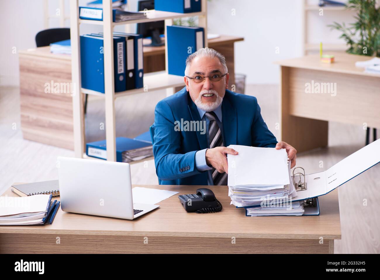 Senior male bookkeeper unhappy with excessive work at workplace Stock ...