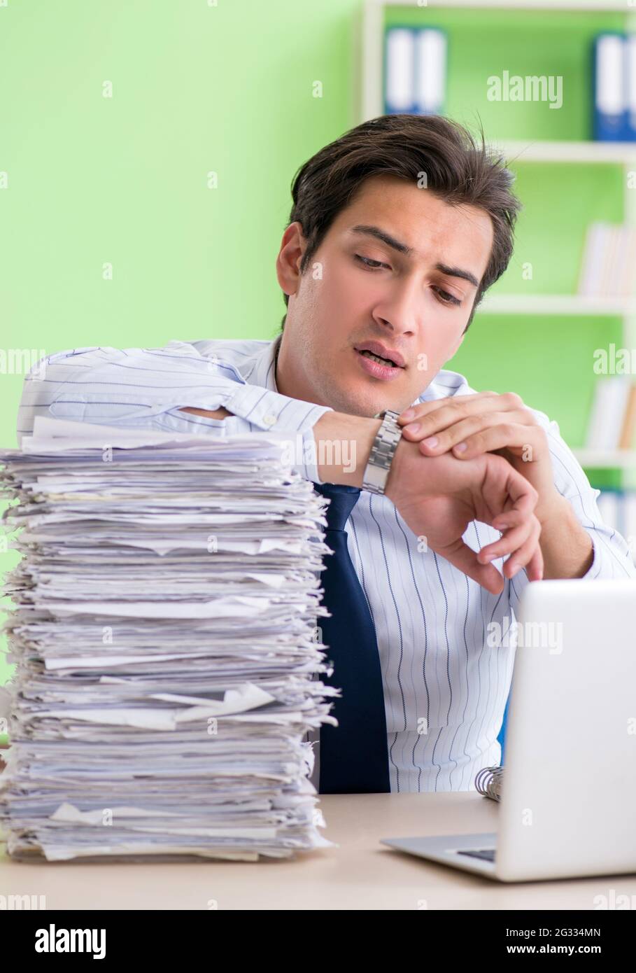 The businessman having problems with paperwork and workload Stock Photo ...