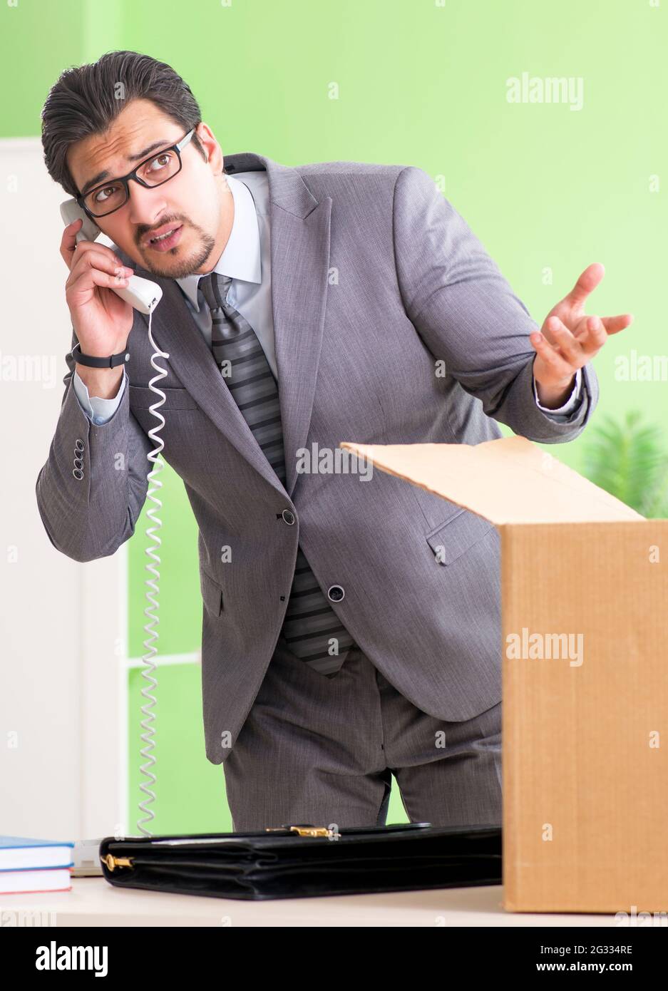The male employee collecting his stuff after redundancy Stock Photo - Alamy