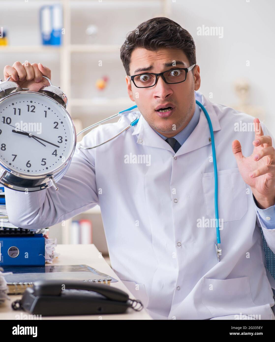 The doctor with alarm clock in urgent check-up concept Stock Photo - Alamy