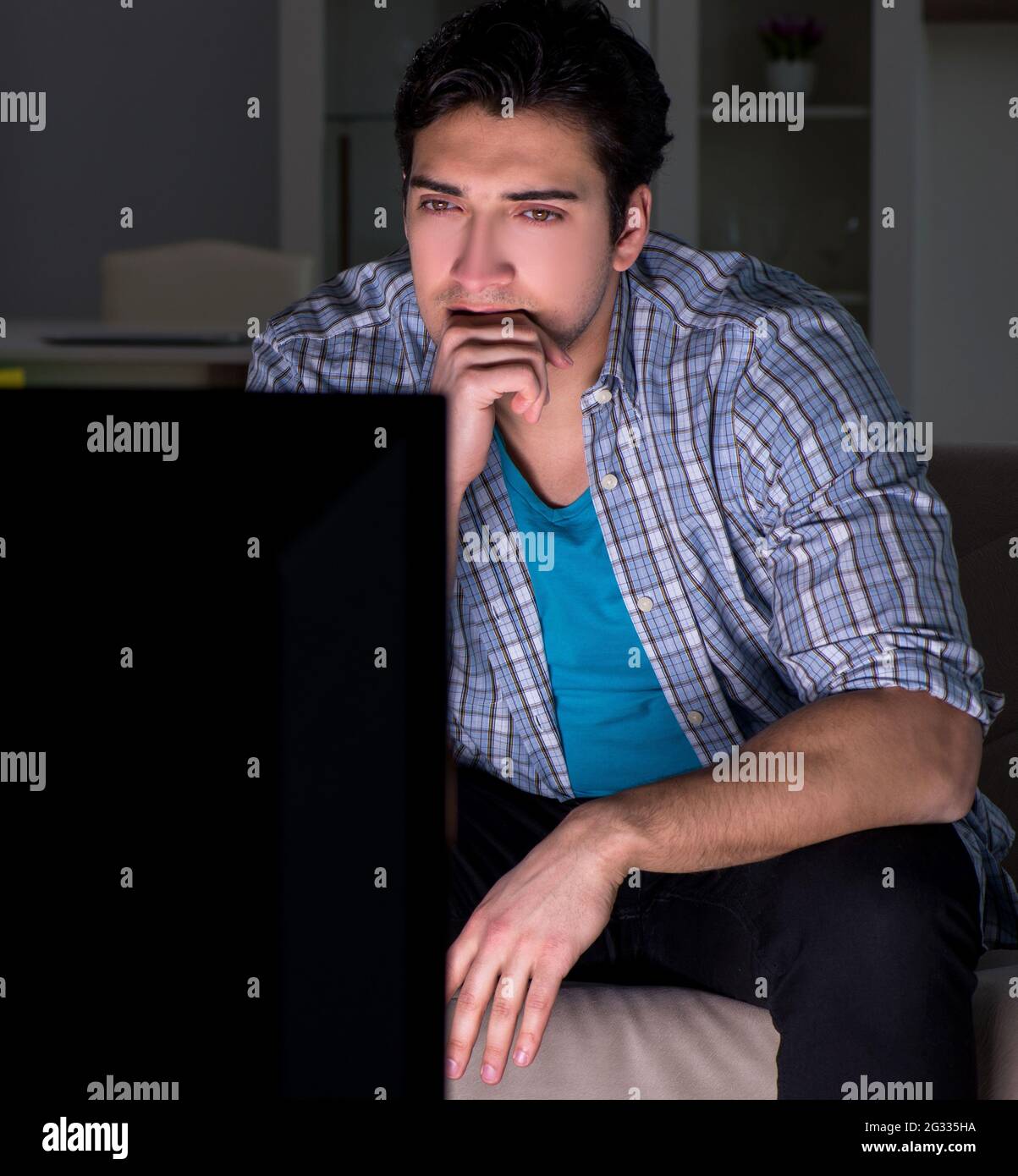 The young man watching tv late at night Stock Photo - Alamy