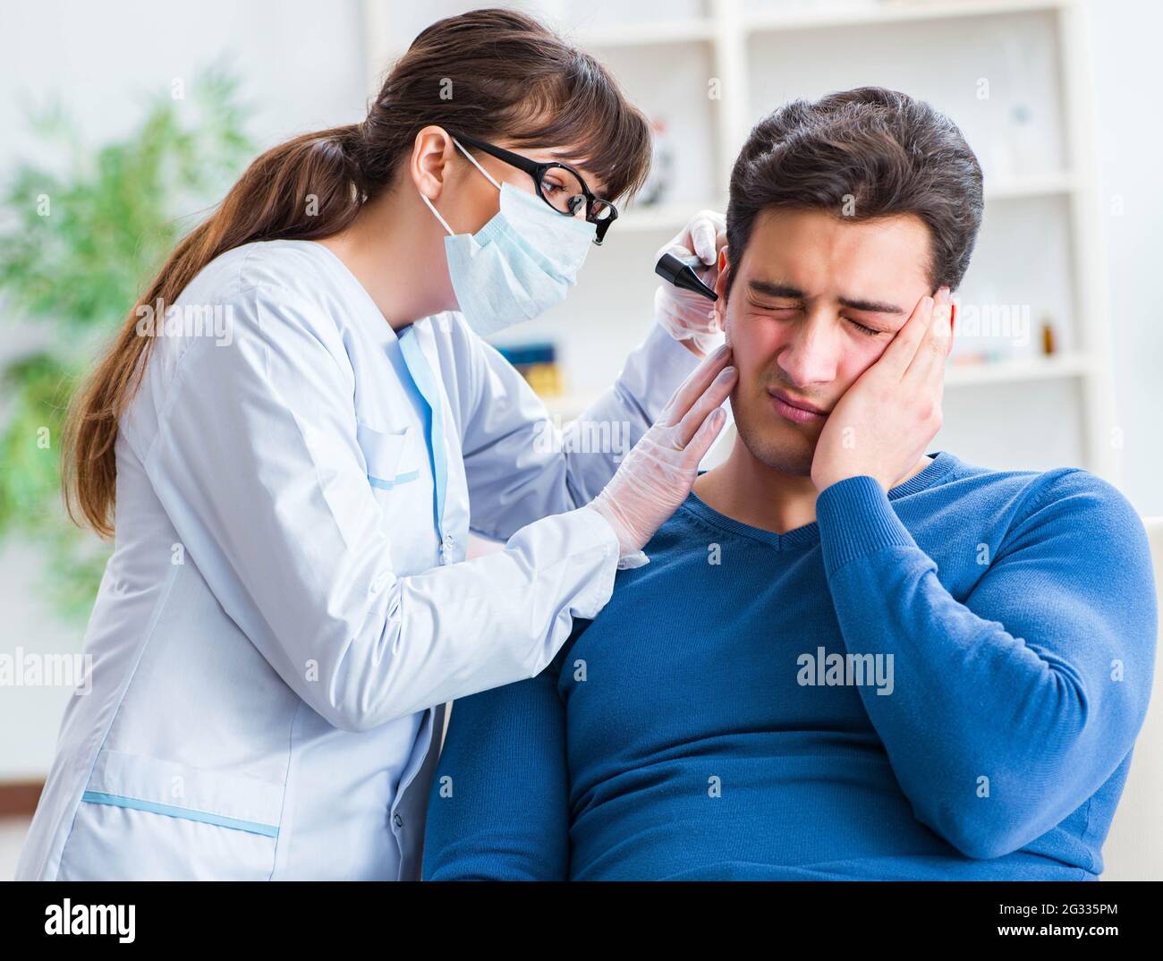 The doctor checking patients ear during medical examination Stock Photo ...