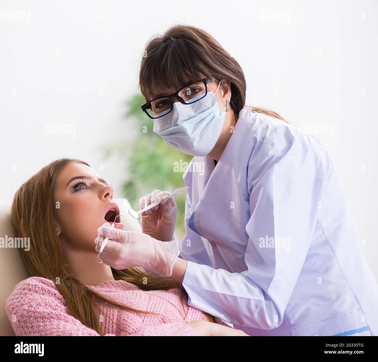 The woman patient visiting dentist for regular check-up Stock Photo - Alamy