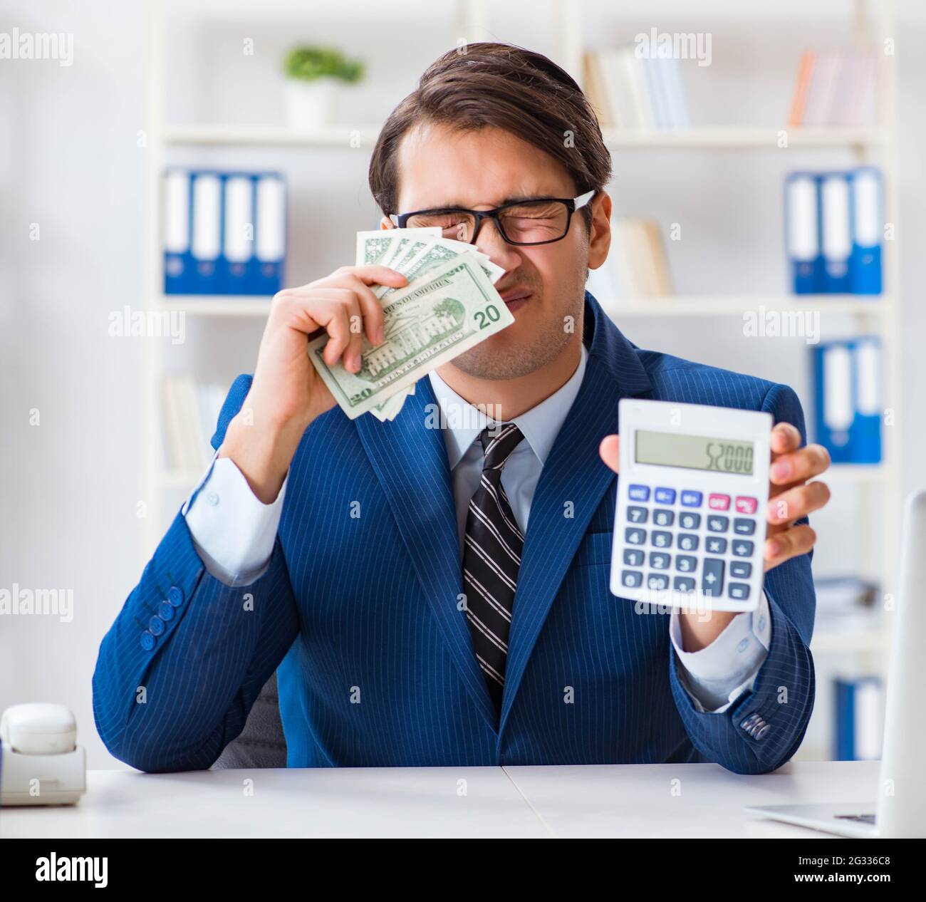 The accountant calculating dollars with calculator in office Stock ...