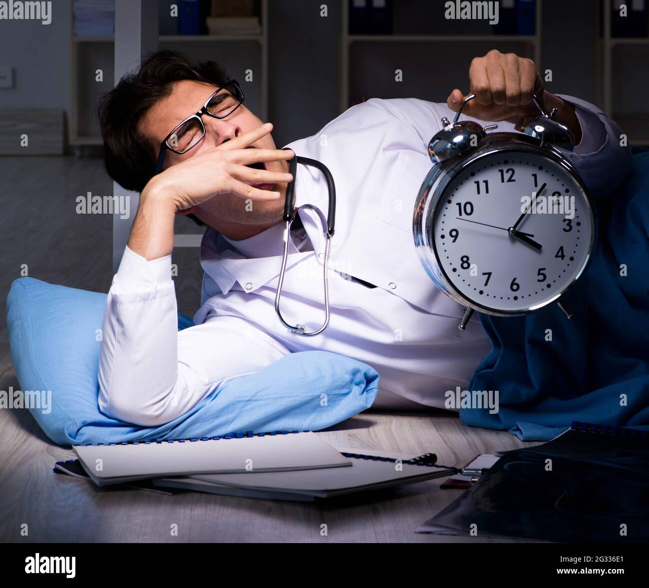 The doctor working night shift in hospital after long hours Stock Photo ...