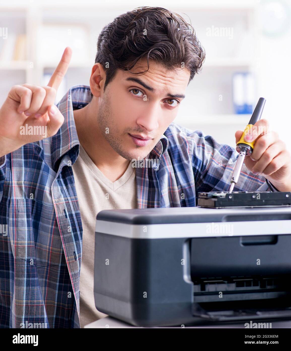 The hardware repairman repairing broken printer fax machine Stock Photo ...