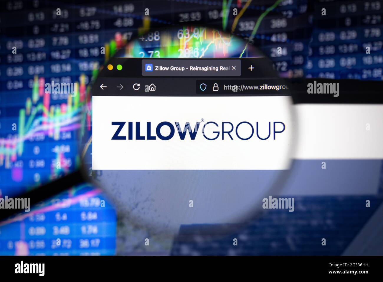 Zillow Group company logo on a website with blurry stock market ...