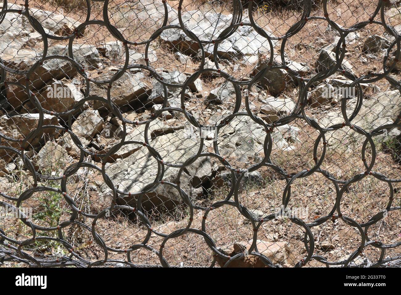 Steel barrier net with a ring design protects against rockslides ...