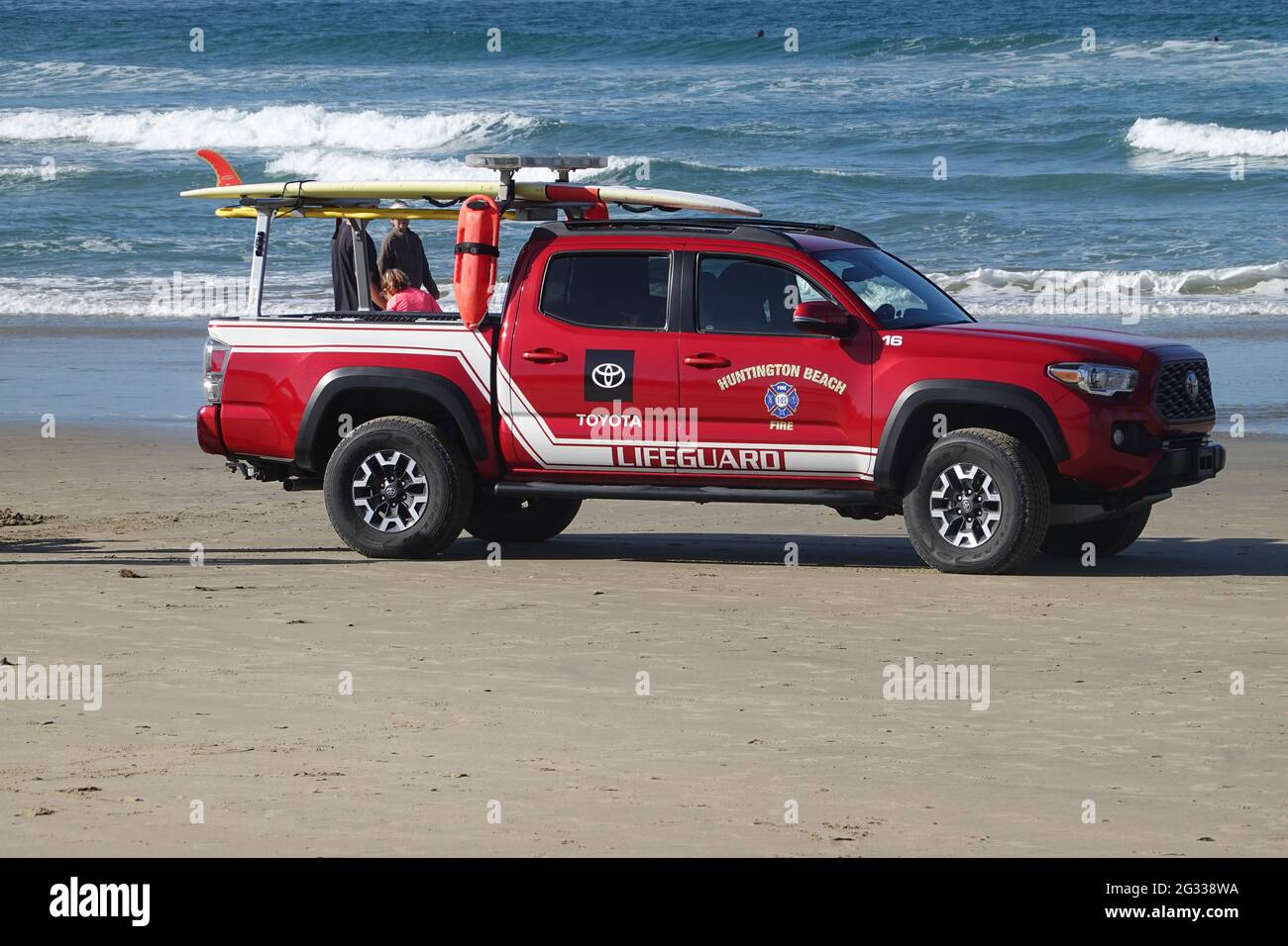 Red lifeguard truck on beach patrol at the waters edge Huntington beach ...