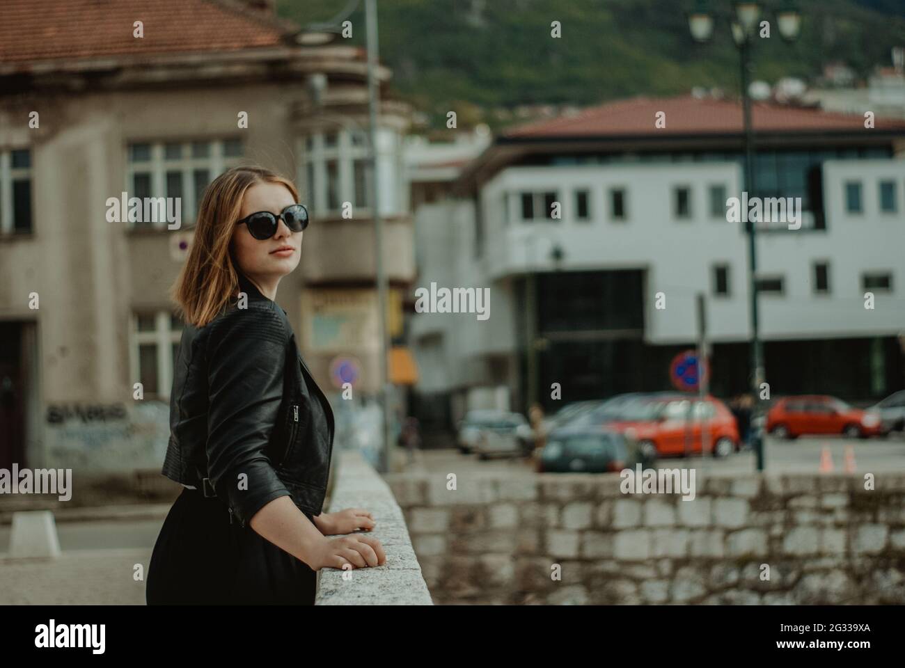 An attractive stylish female posing on a bridge Stock Photo - Alamy
