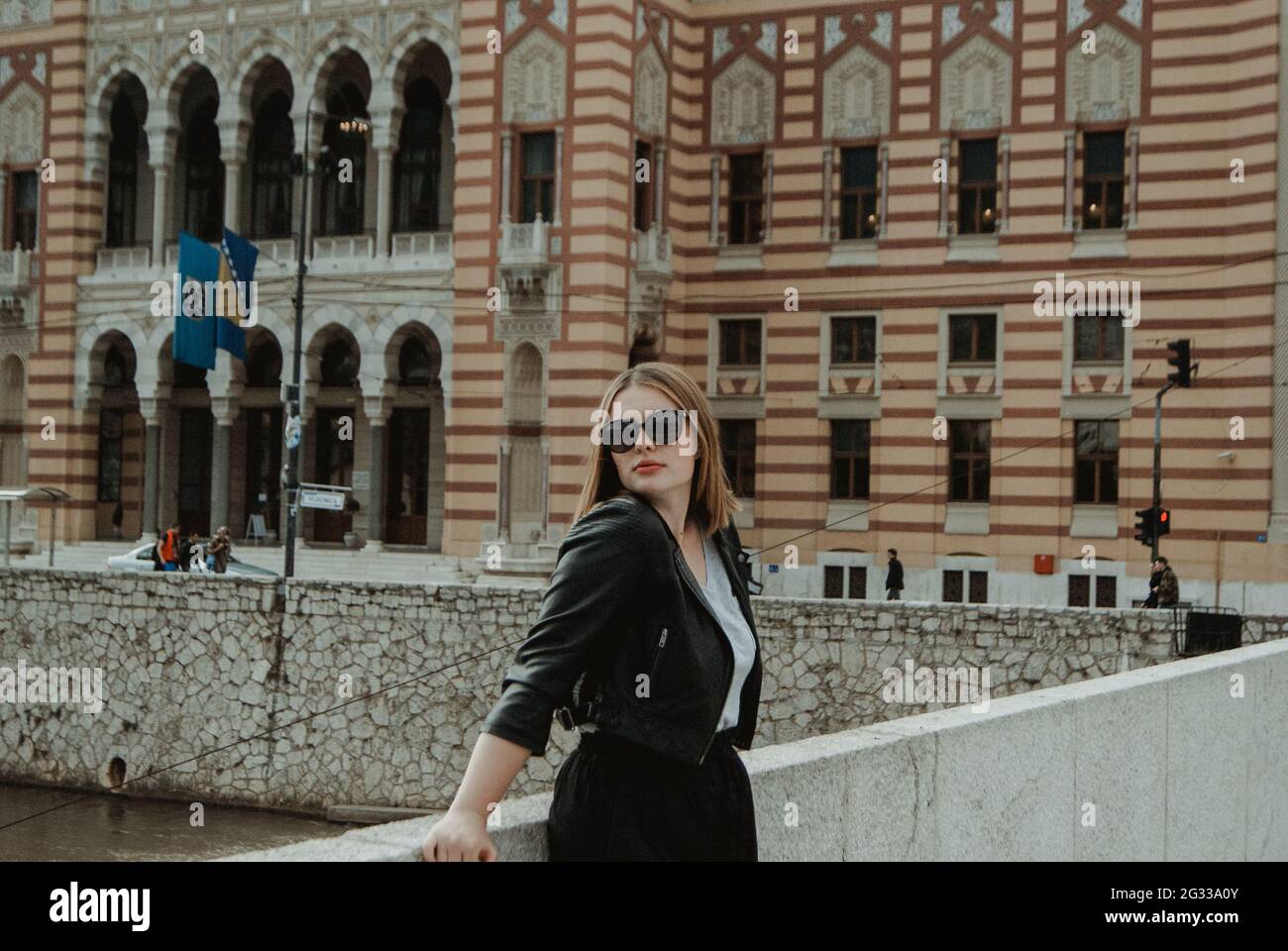 An attractive stylish female posing on a bridge Stock Photo - Alamy
