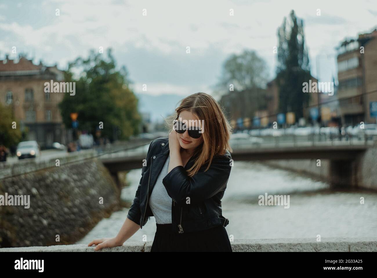 An attractive stylish female posing on a bridge Stock Photo - Alamy