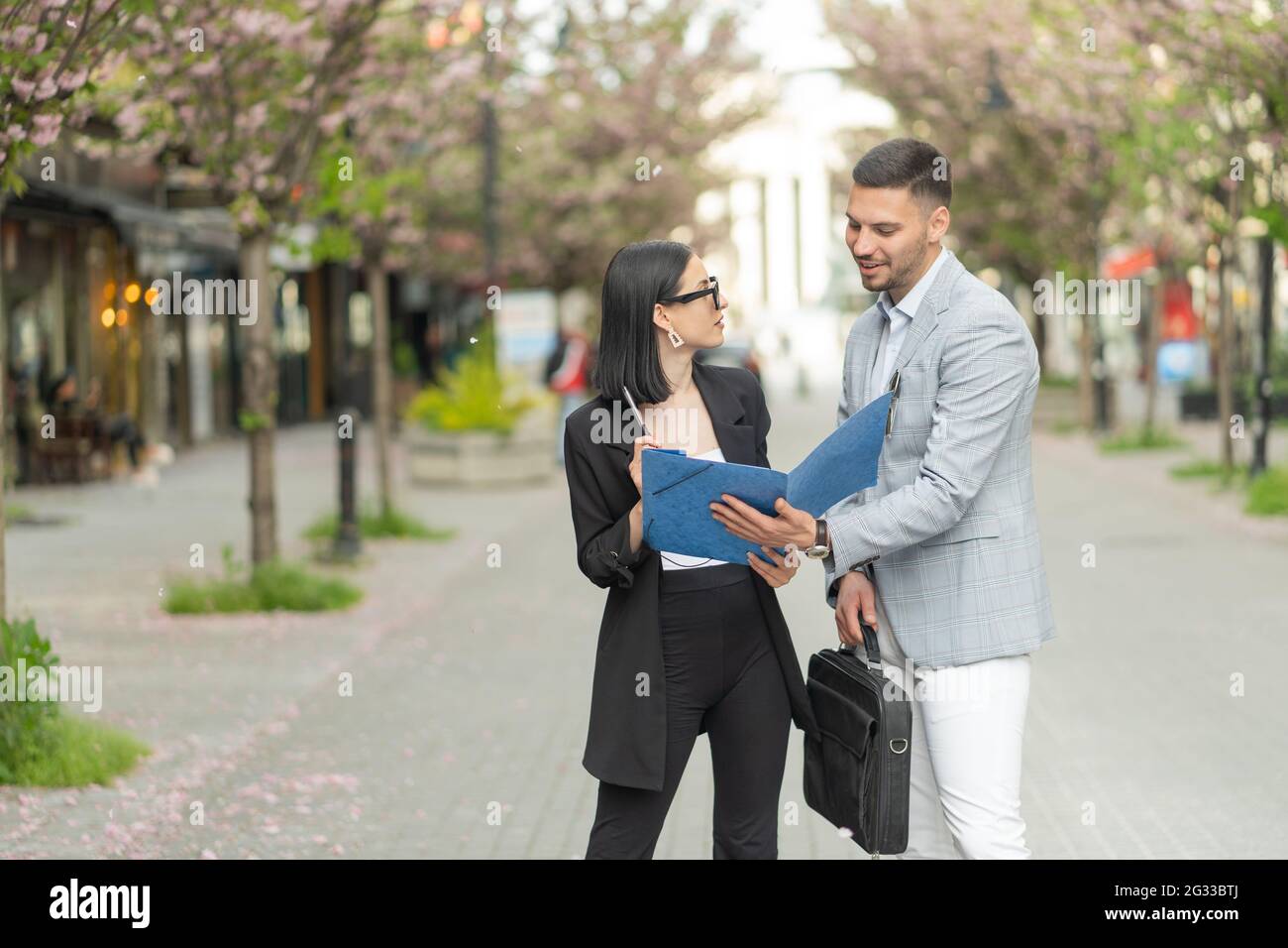 Two business people are having a conversation about the new plans Stock ...