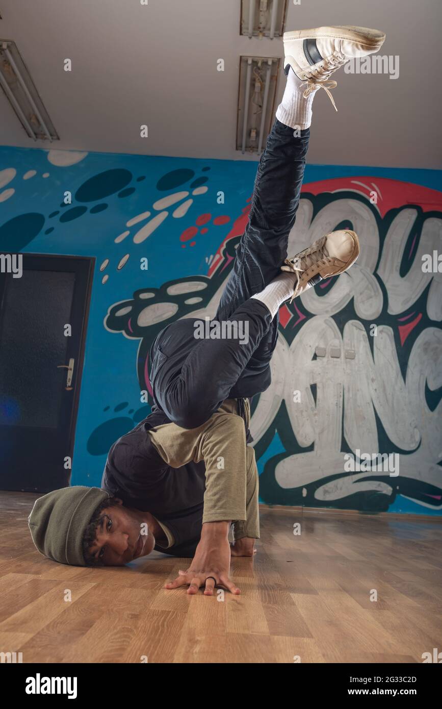 Modern rapper dancing in garage. Urban lifestyle, hip hop Stock Photo ...