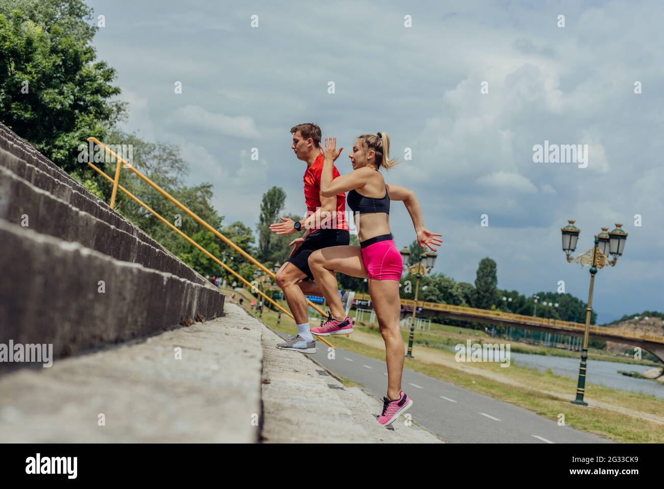 Healthy active couple exercising cardio and sprinting staircase in a ...