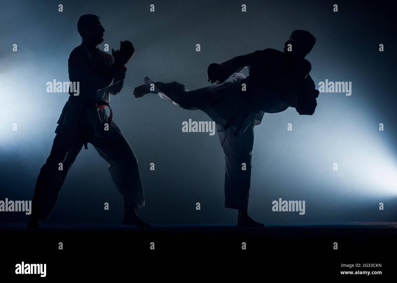 A young strong man in a white kimono for sambo, jiu jitsu and other ...
