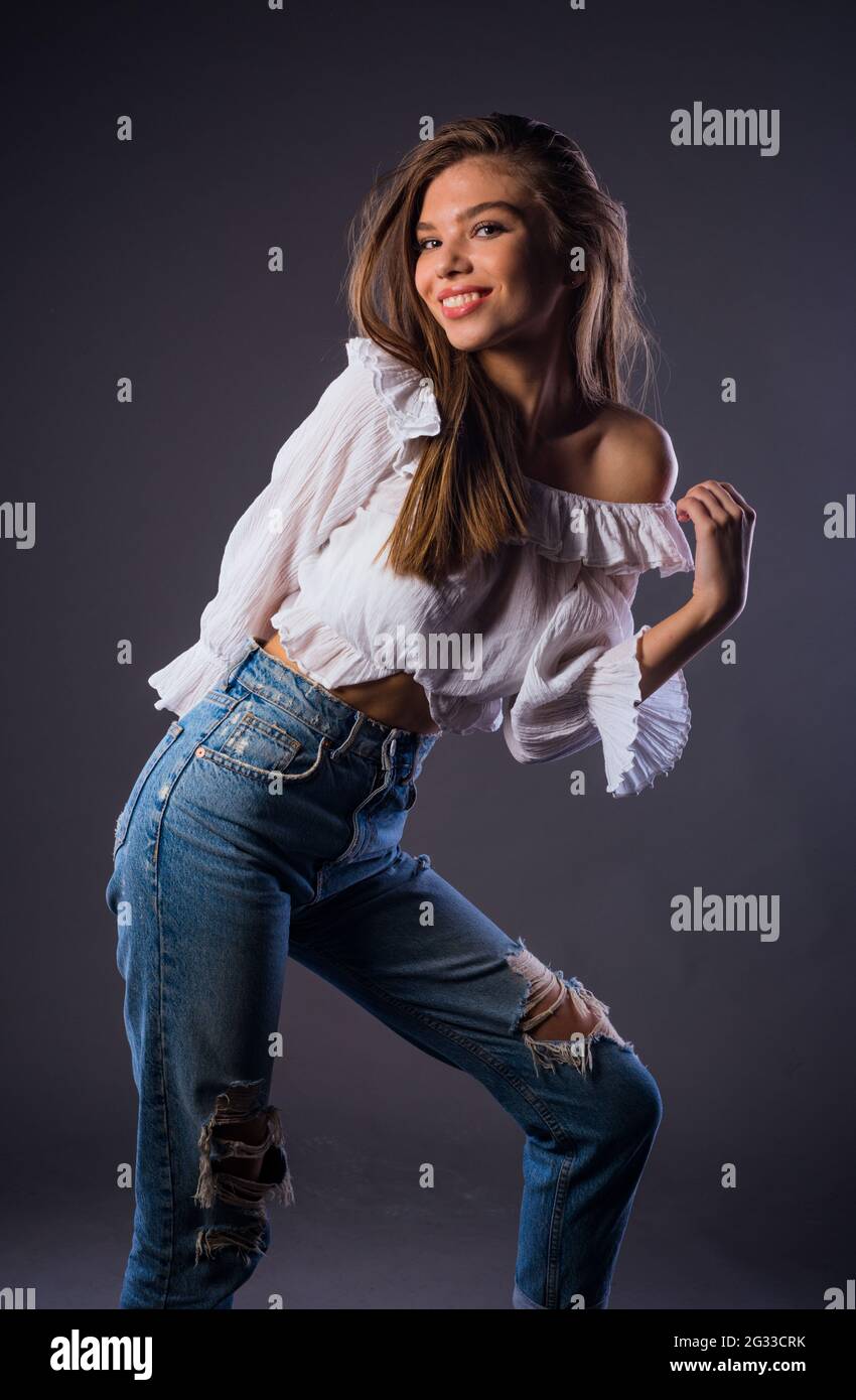 Studio body shot of a trendy woman wearing modern skinny pants, white ...