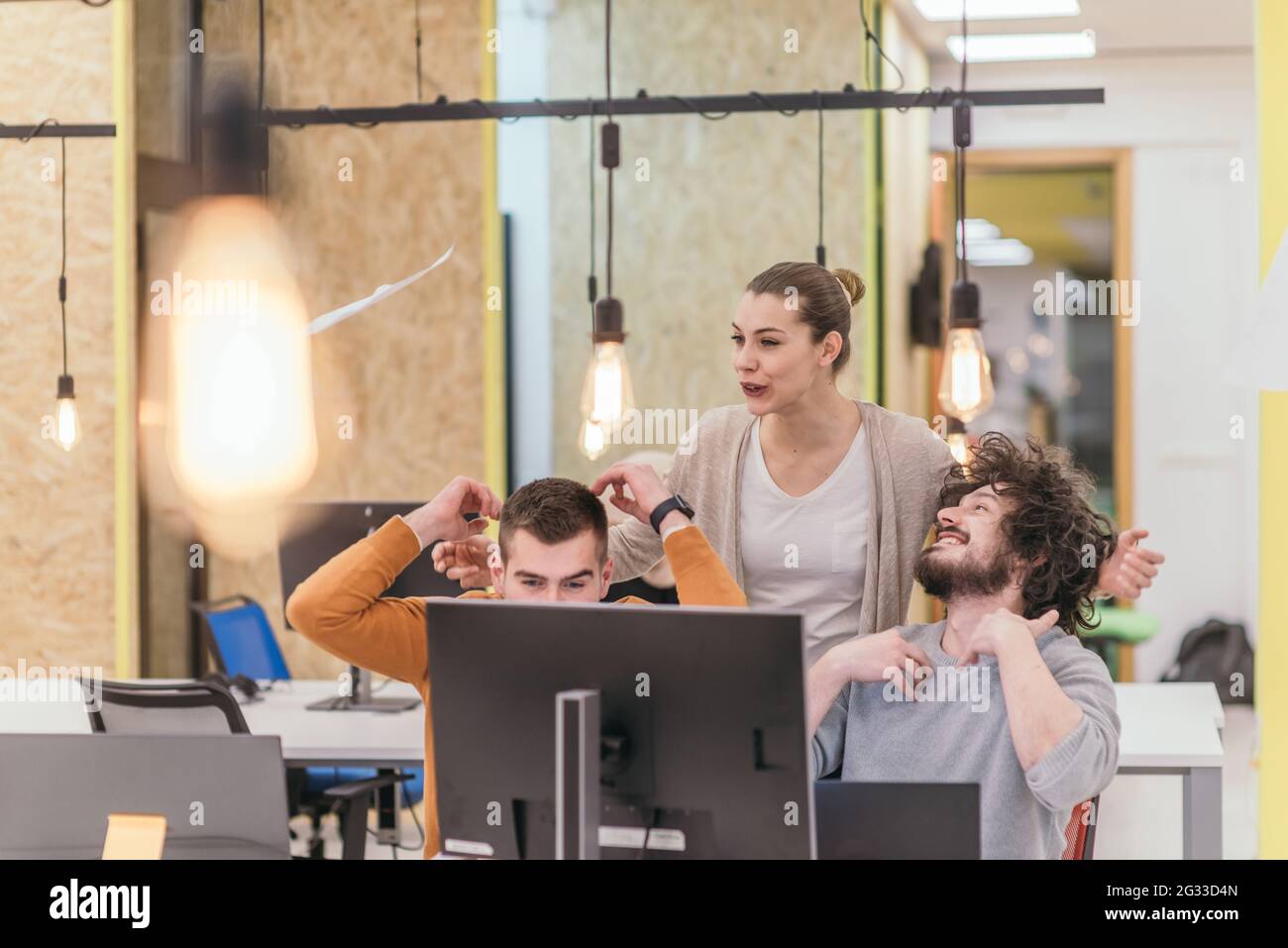 Group of coworkers, colleagues having fun at the office while chatting ...