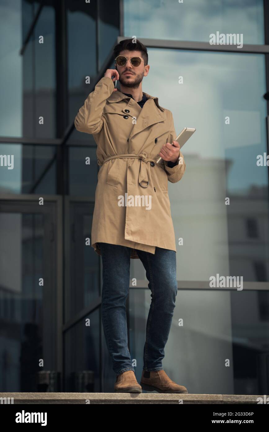 Well suited businessman is talking with his partners on the phone Stock ...