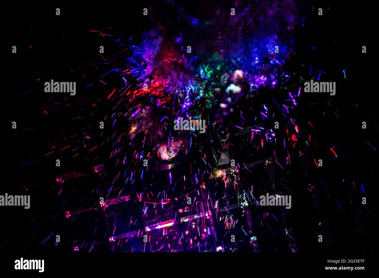 Colored water texture. Splashes of water lit in different colors. Close ...