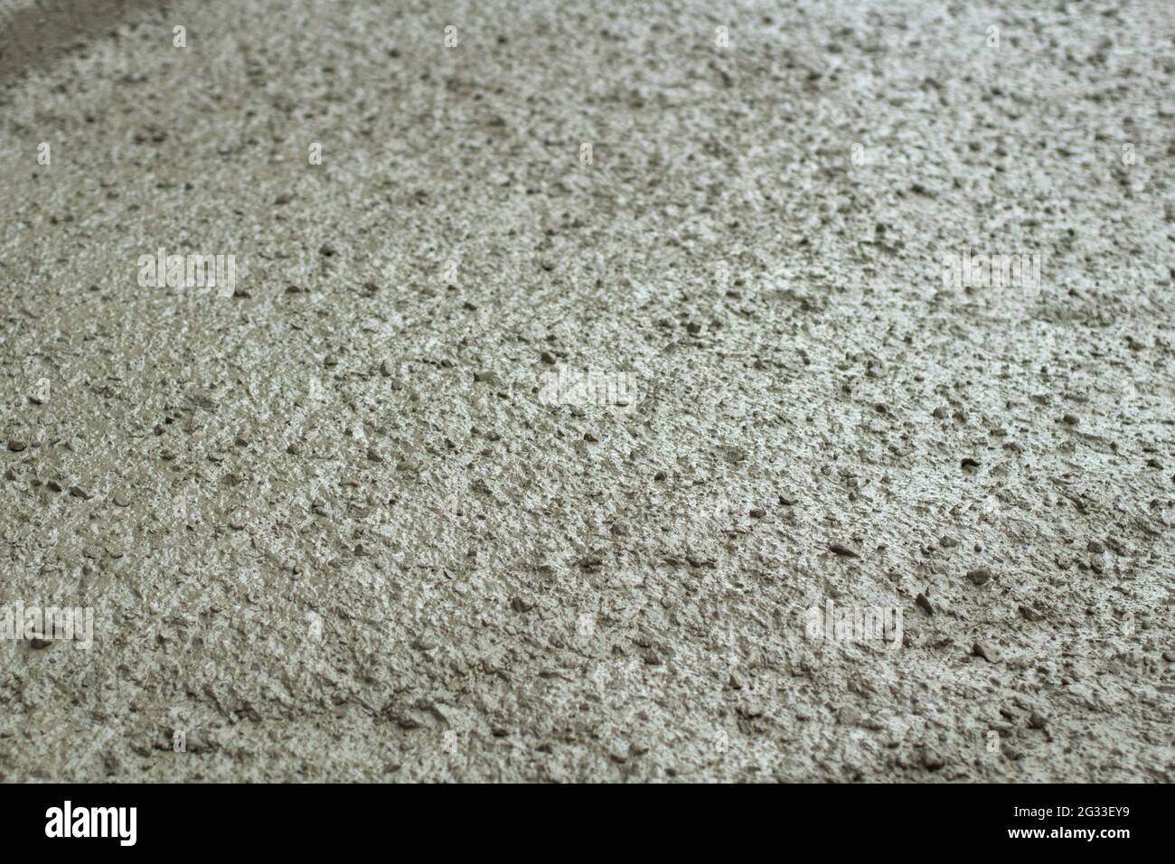 Liquid cement at a construction site. Cement spilled onto the road. The ...