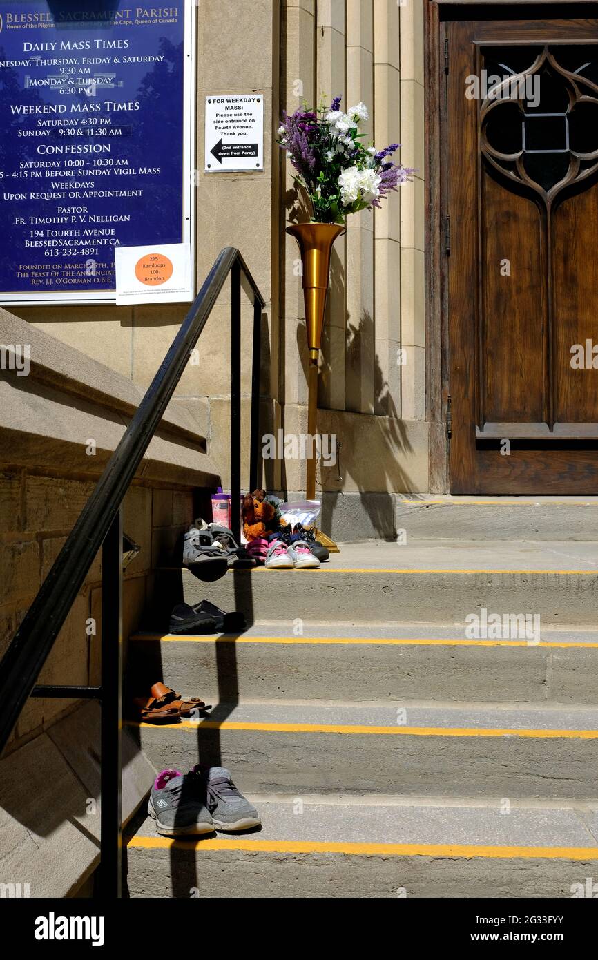 Childrens shoes placed on the steps of the local Catholic church in ...
