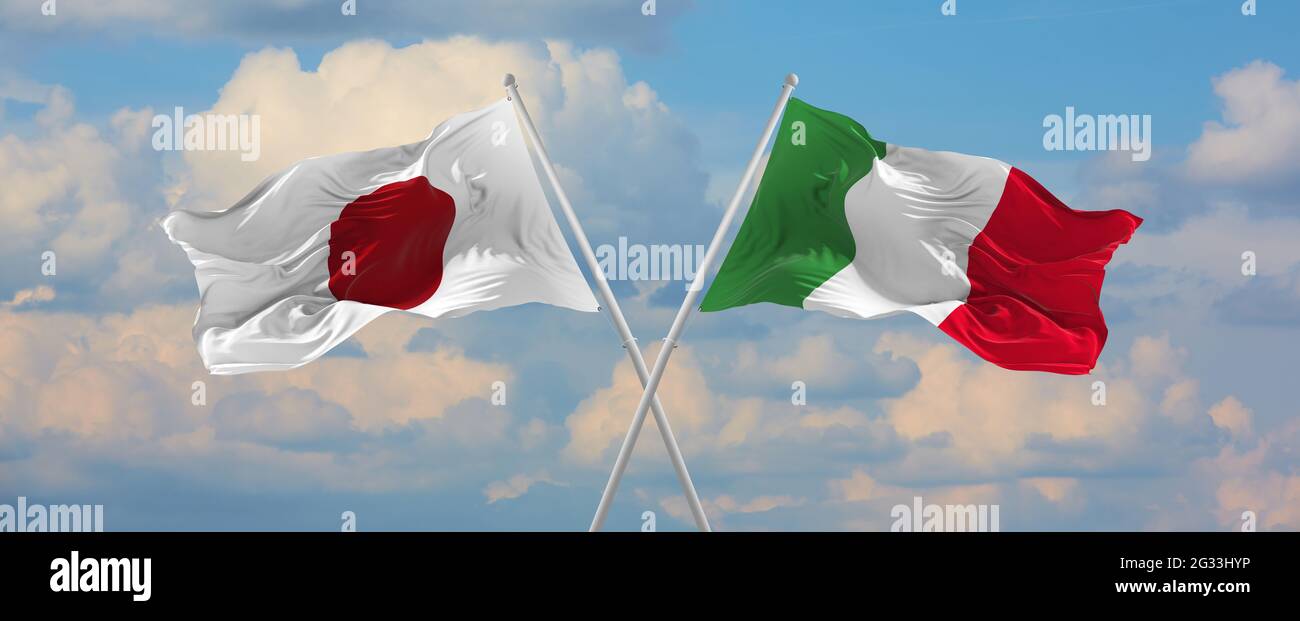 flags of Japan and Italia waving in the wind on flagpoles against sky ...
