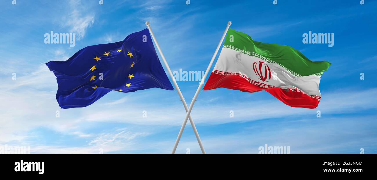 flags of European Union and Iran waving in the wind on flagpoles ...