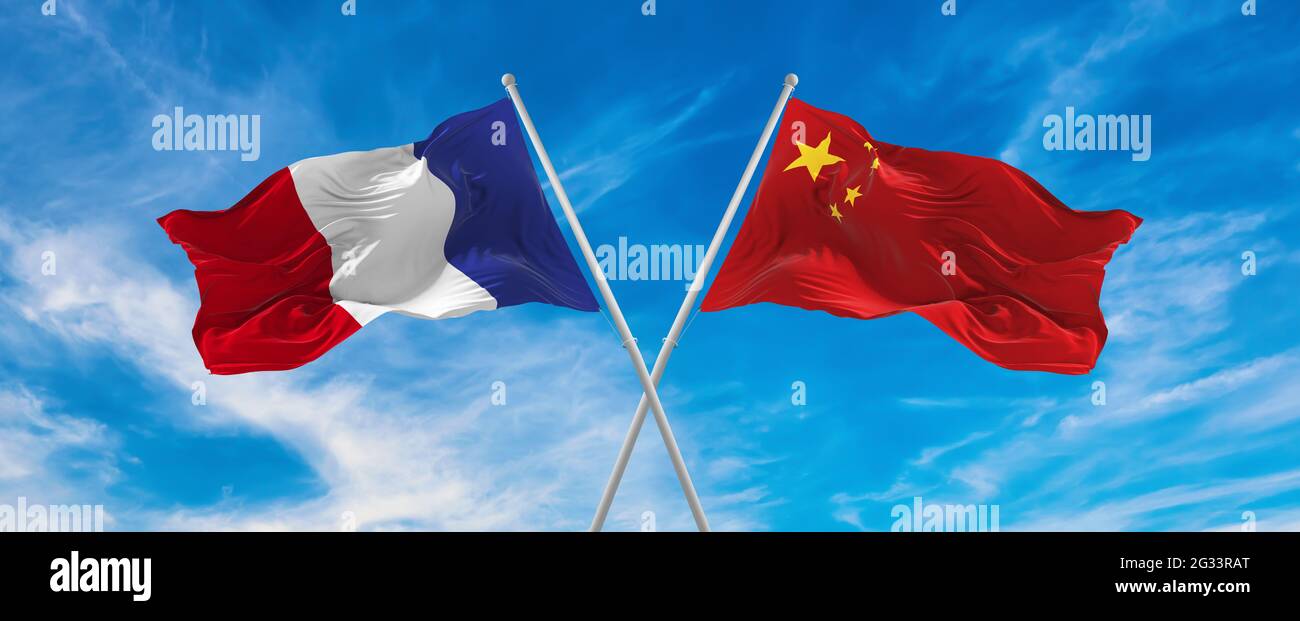 flags of China and France waving in the wind on flagpoles against sky ...