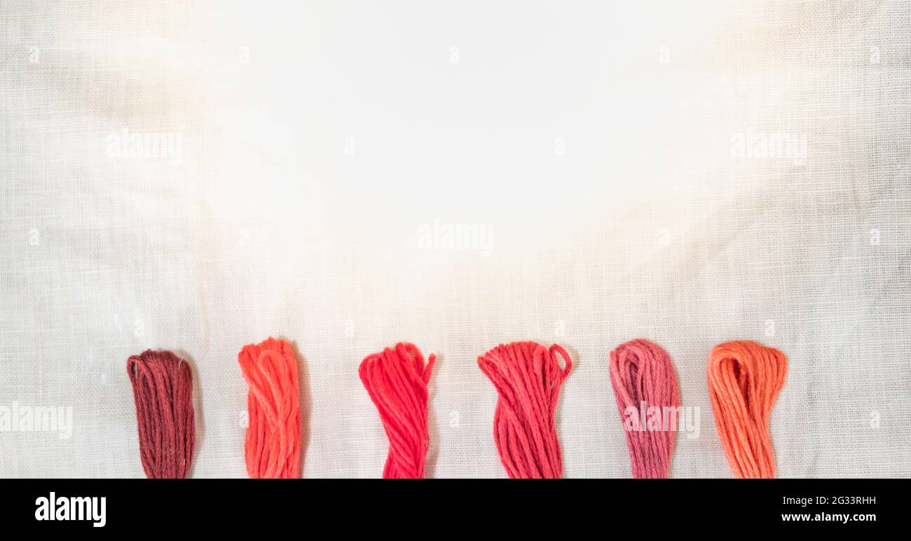 The red and pink tone threads for embroidery cross-stitch on white ...