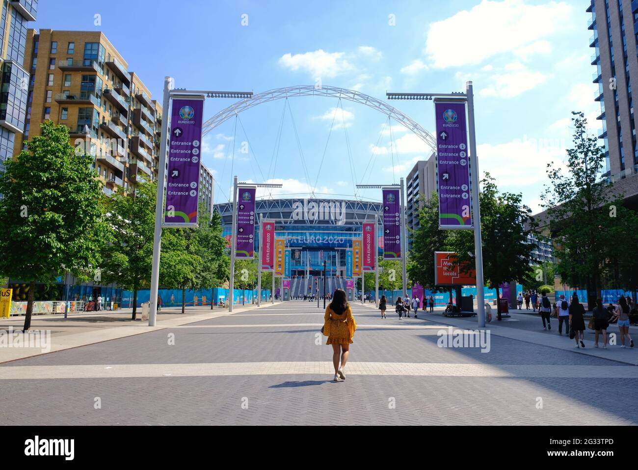 London, UK. A woman walks along Olympic Way leading to Wembley Stadium ...