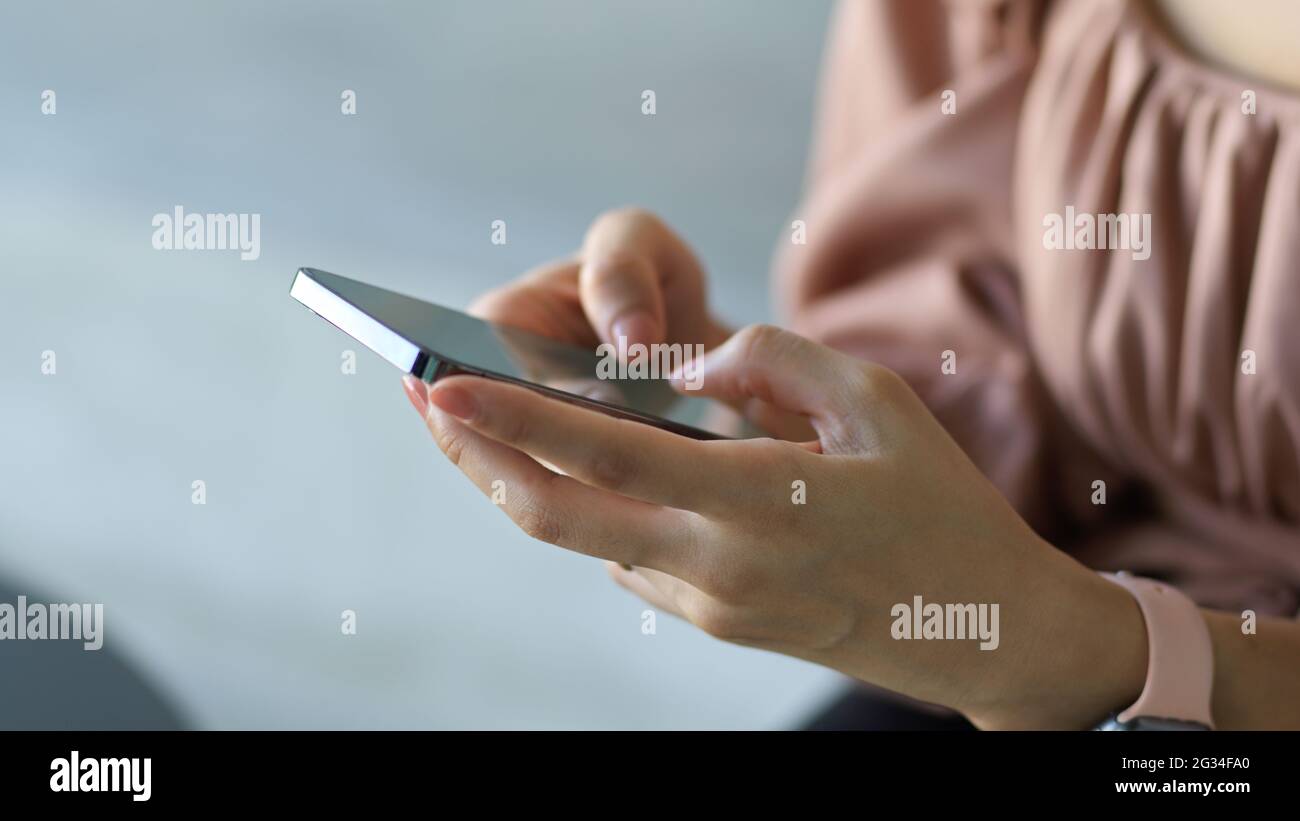 Close up view of female office hands texting message on smartphone ...