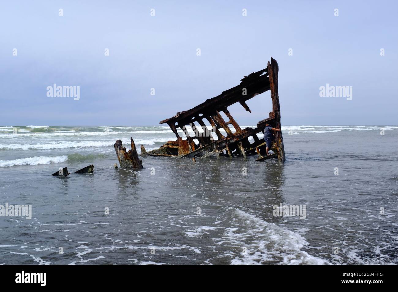 Climbing on the wreck of the Peter Iredale in Fort Stevens State Park ...