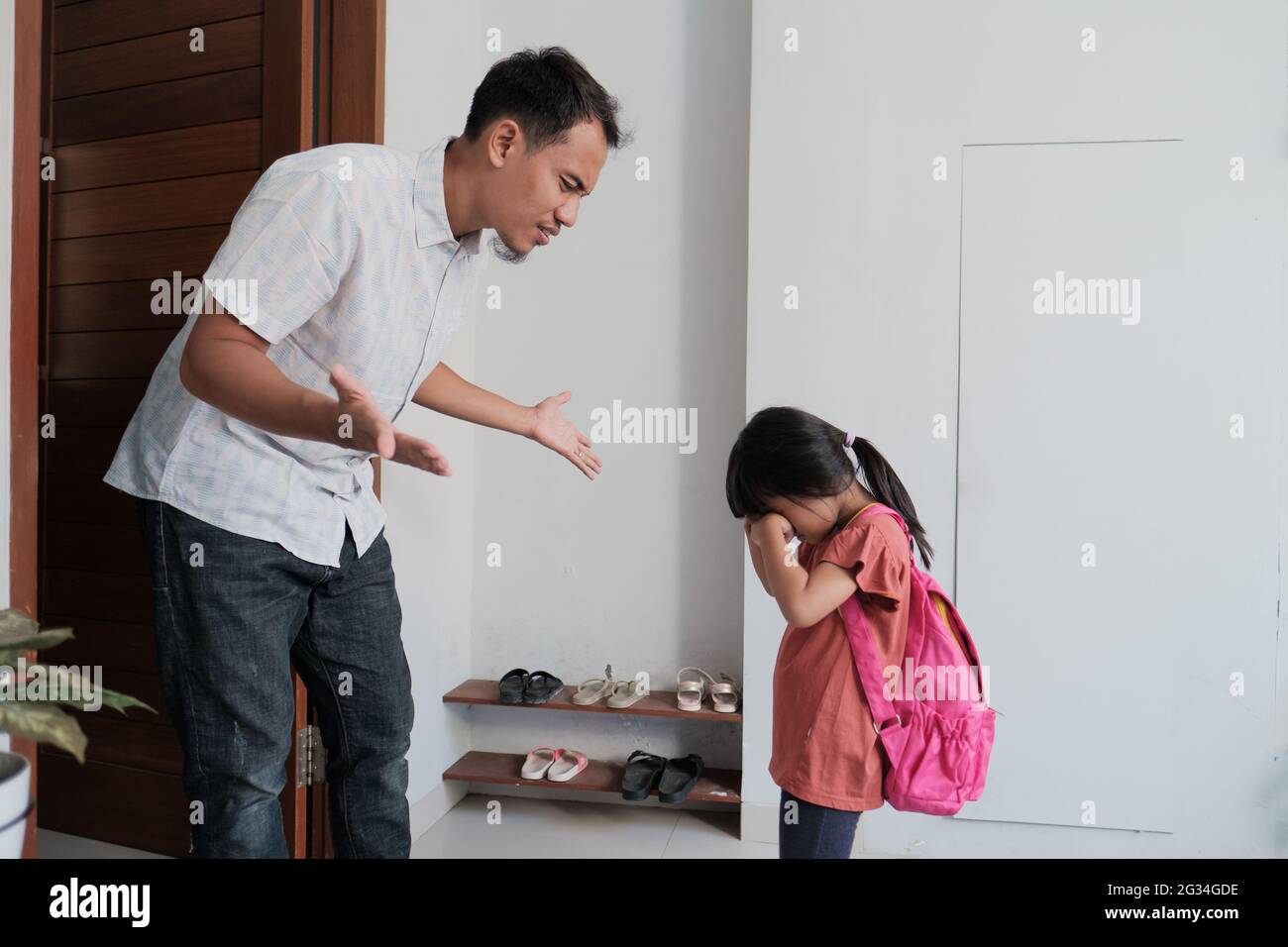 angry father confront his kid after school Stock Photo - Alamy