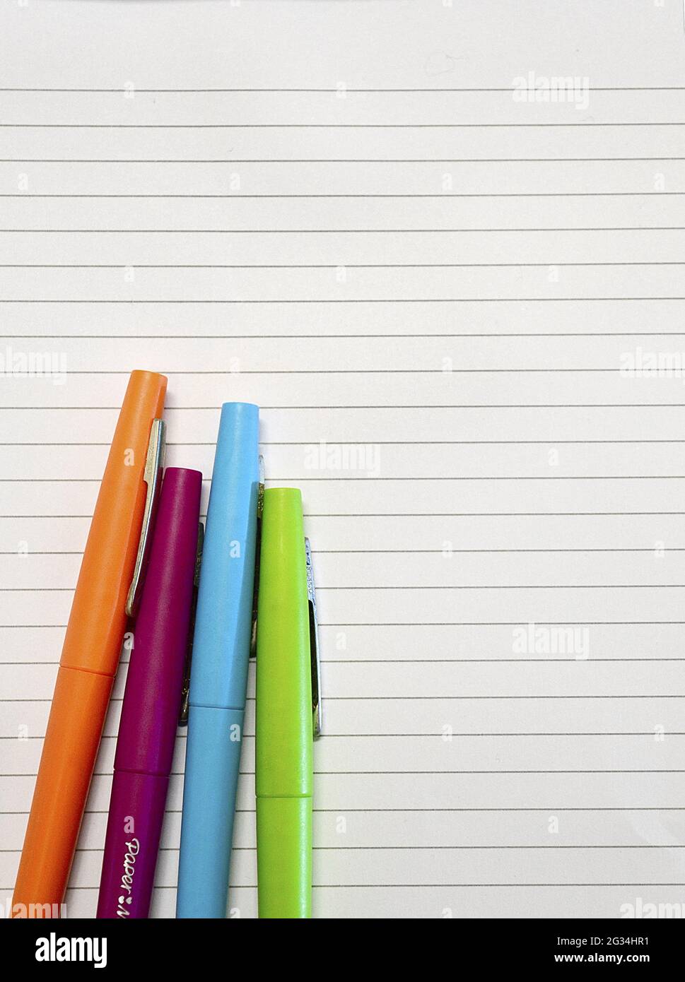 Top view of the colorful plastic pens on the white blank paper Stock ...
