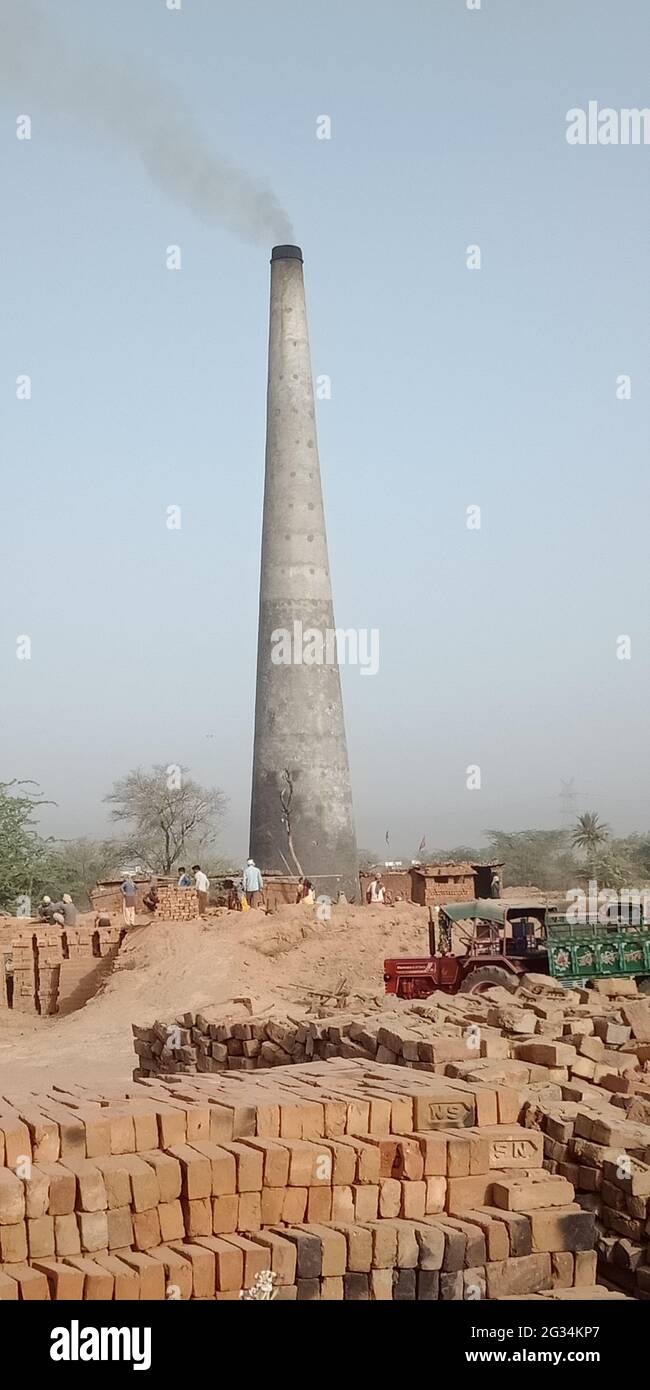 Vertical shot of a brick factory with smoke in India Stock Photo - Alamy