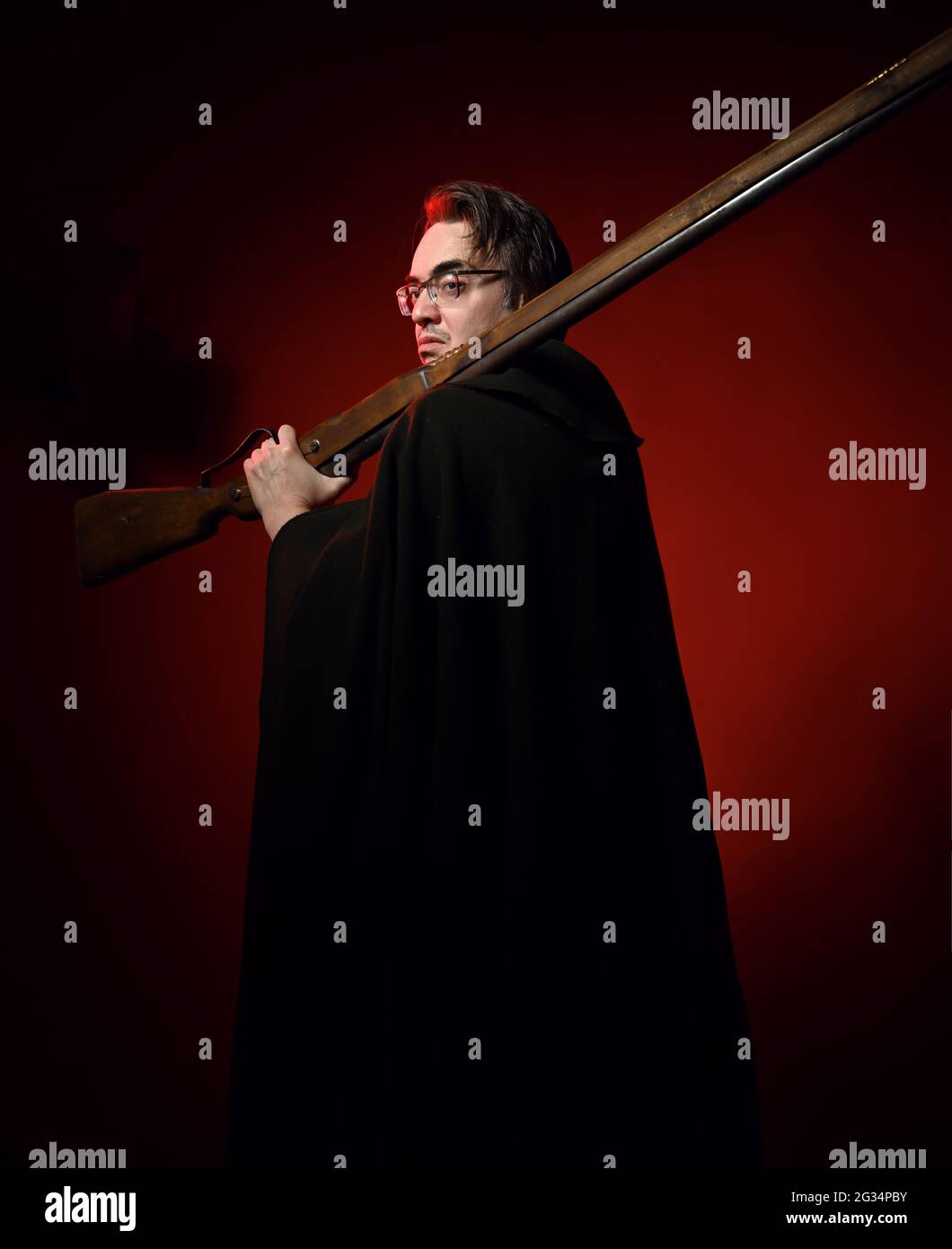 Soldier in cape at patrol is poing pout, standing with his back to us ...