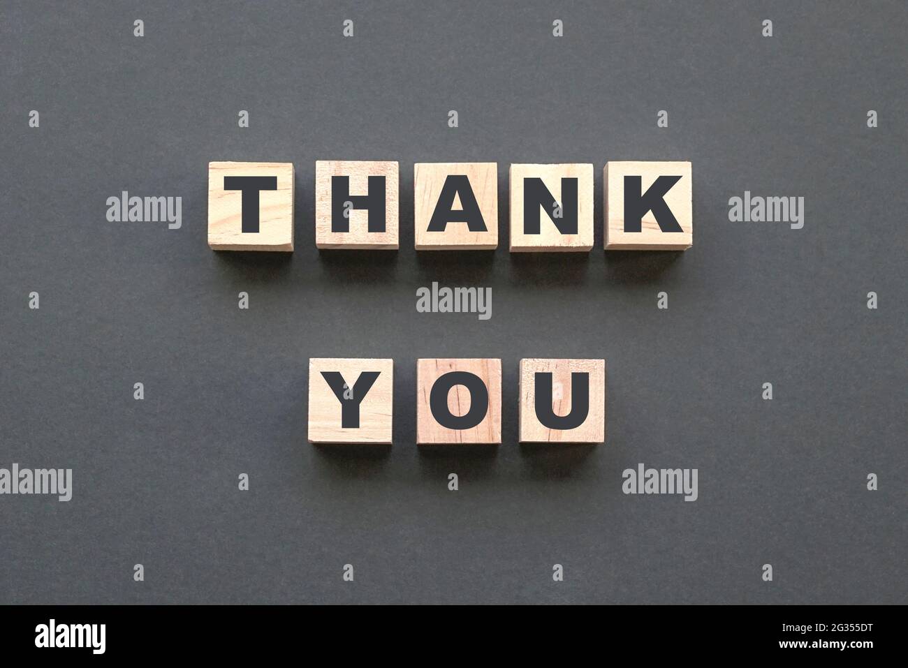 Thank you alphabet letters on wooden blocks on dark grey background ...