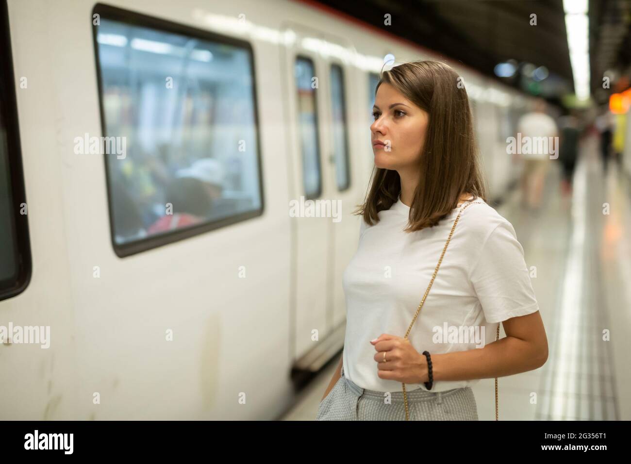 Female on platform of metro station Stock Photo - Alamy
