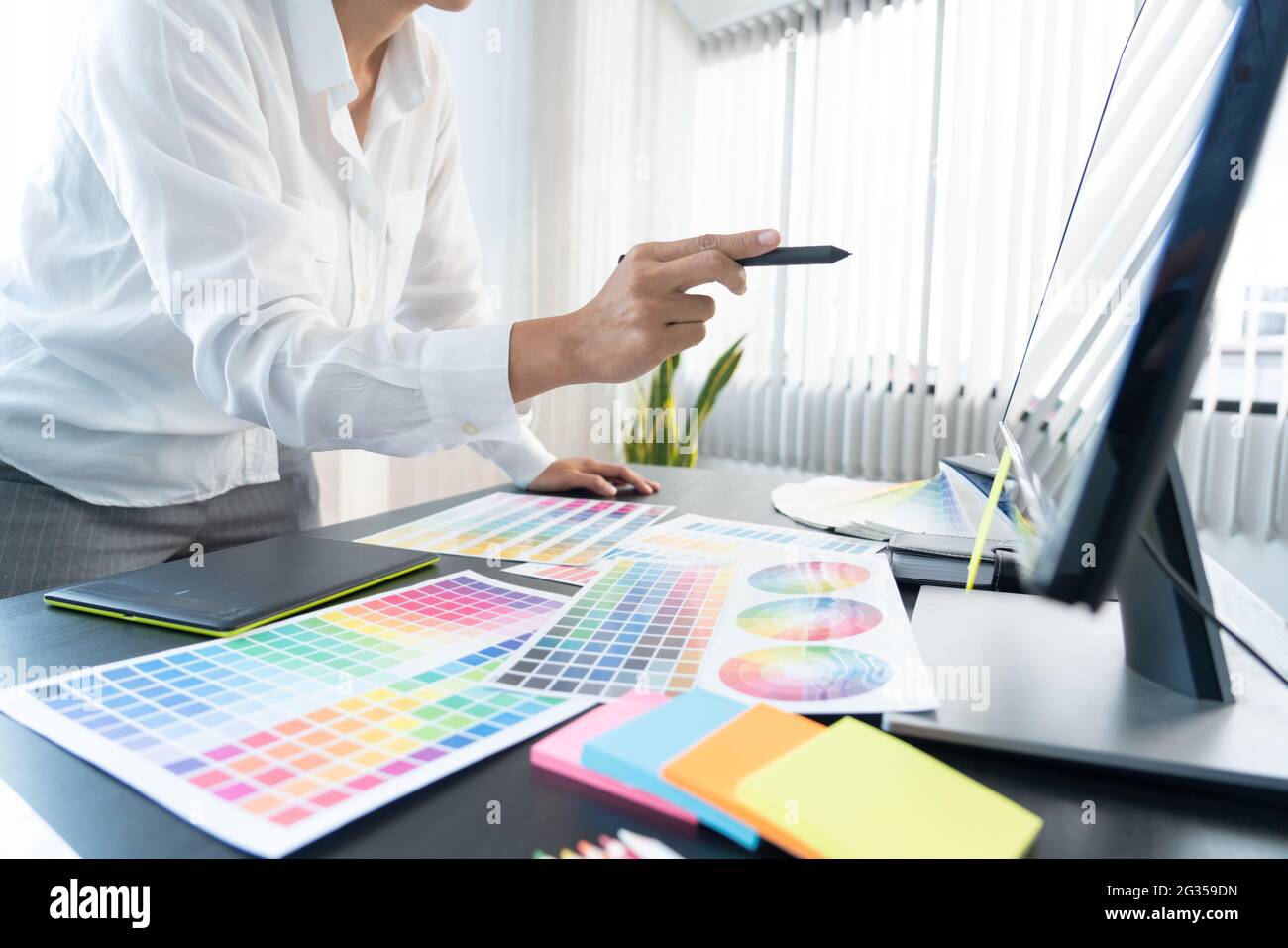creative graphic designer choosing color scale for editing artwork ...