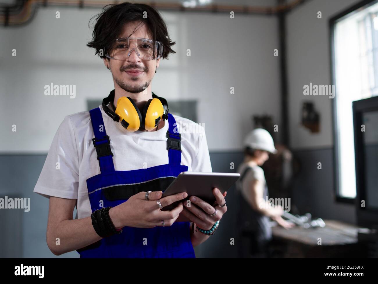 Young man worker in uniform hi-res stock photography and images - Alamy