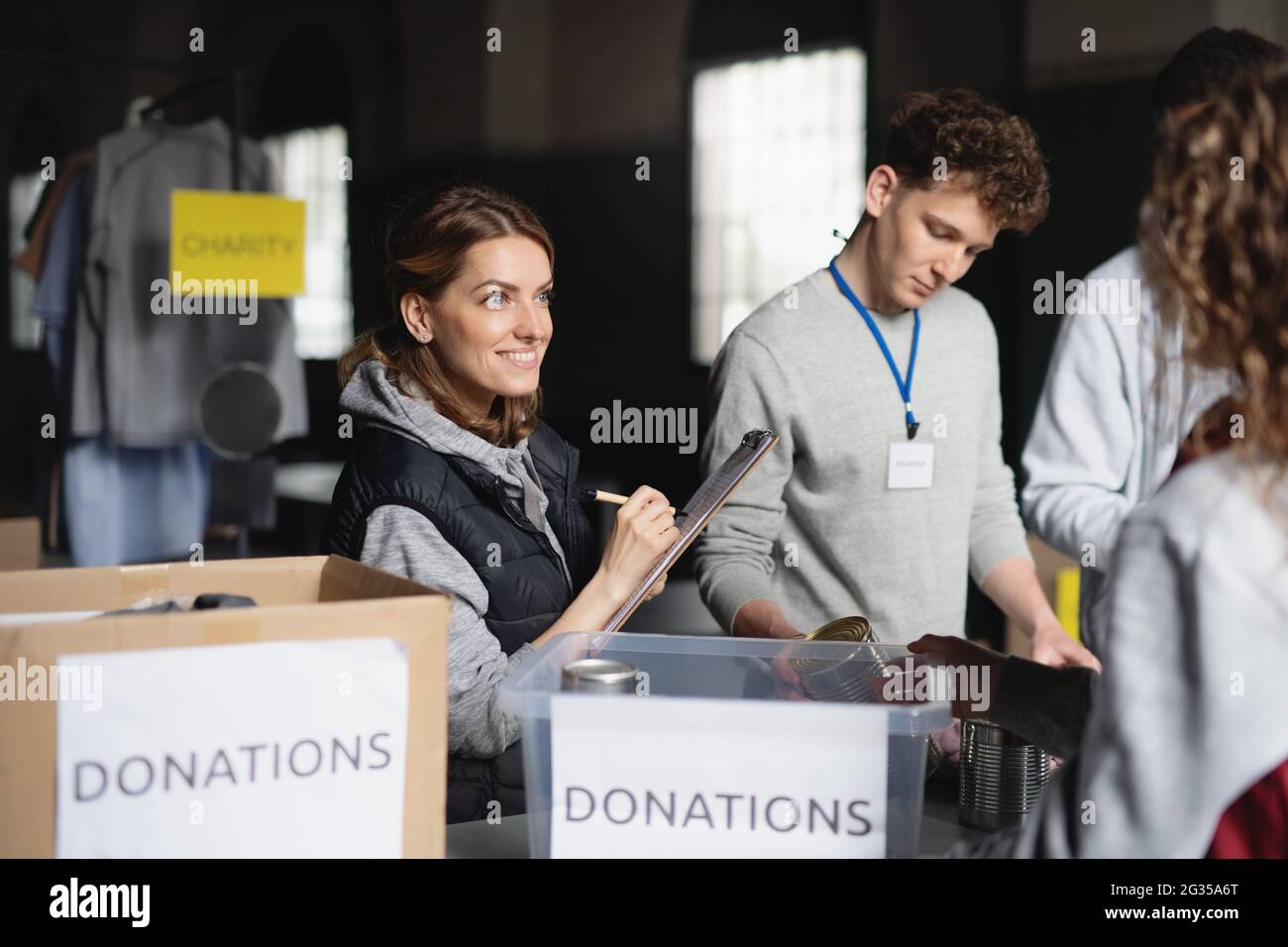 Group of volunteers working in community charity donation center ...