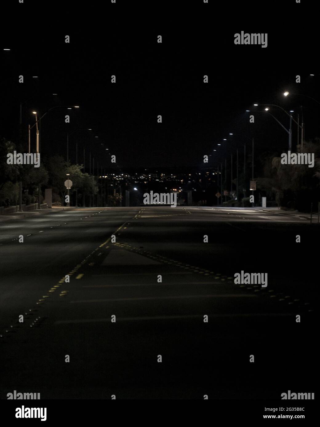 Evening view of an empty city road under a dark sky Stock Photo - Alamy