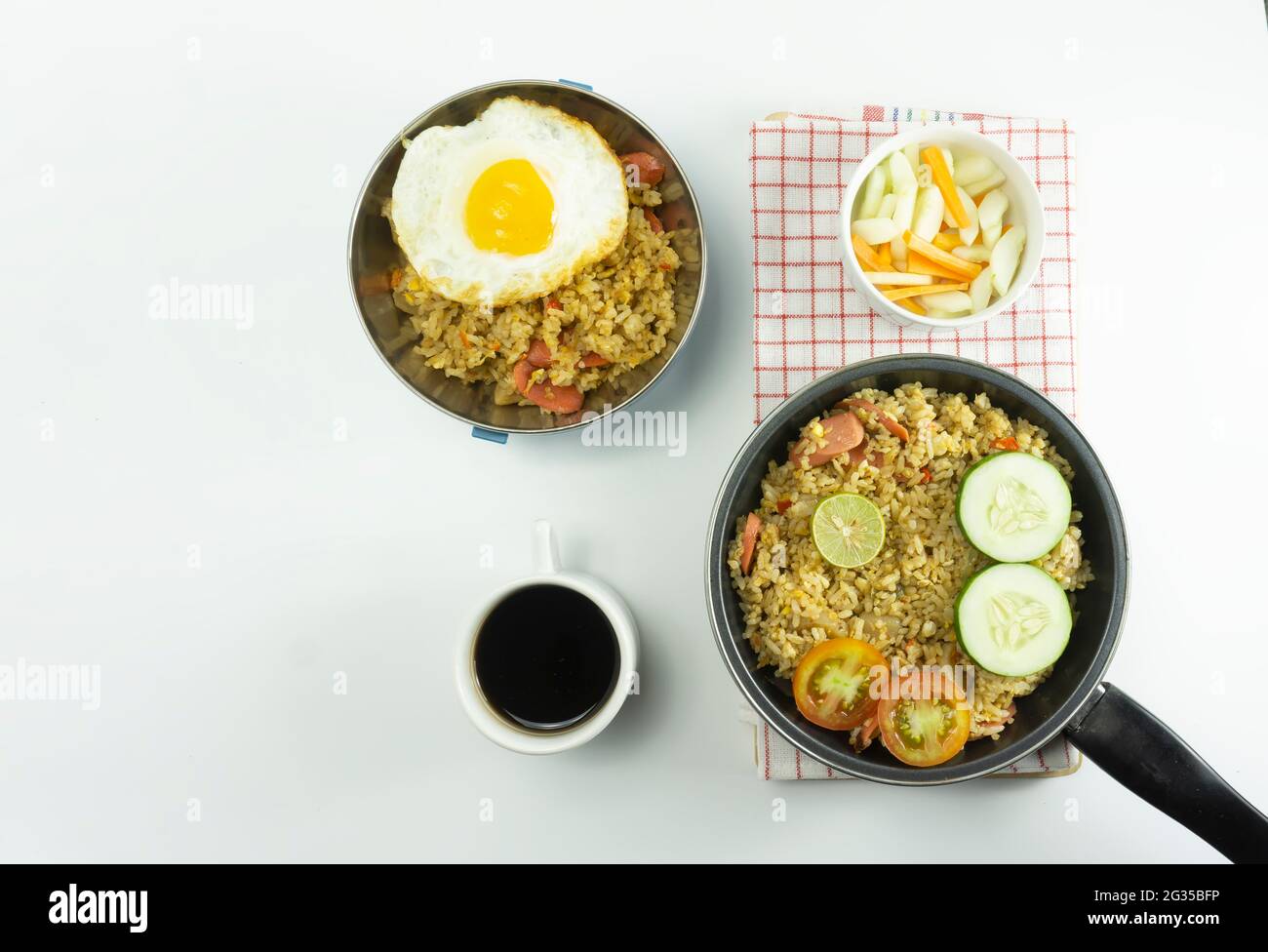 Fried rice served with fresh tomatoes and meatballs in a teflon bowl ...