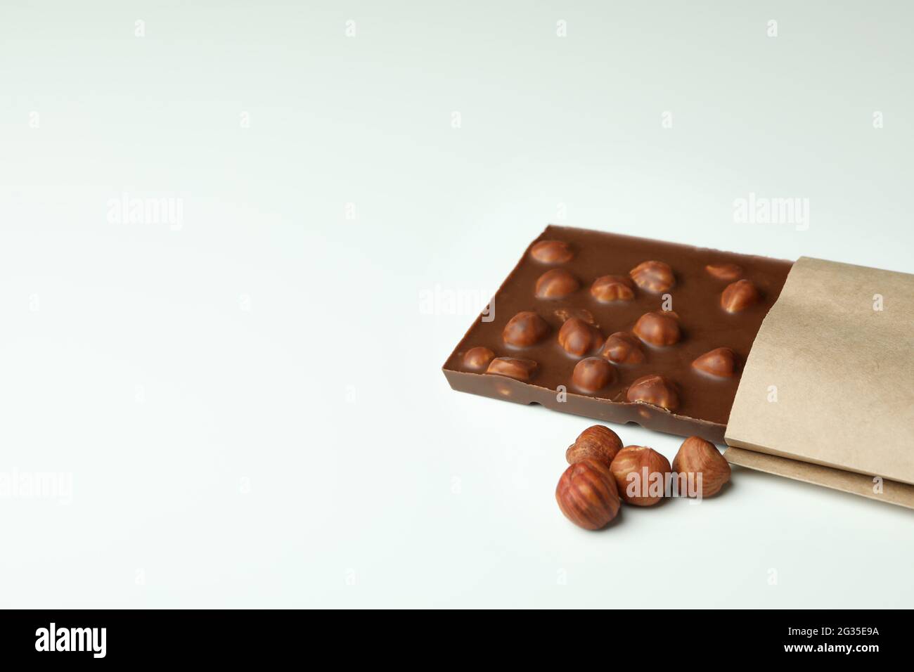 Tasty chocolate bar in paper on white background Stock Photo - Alamy