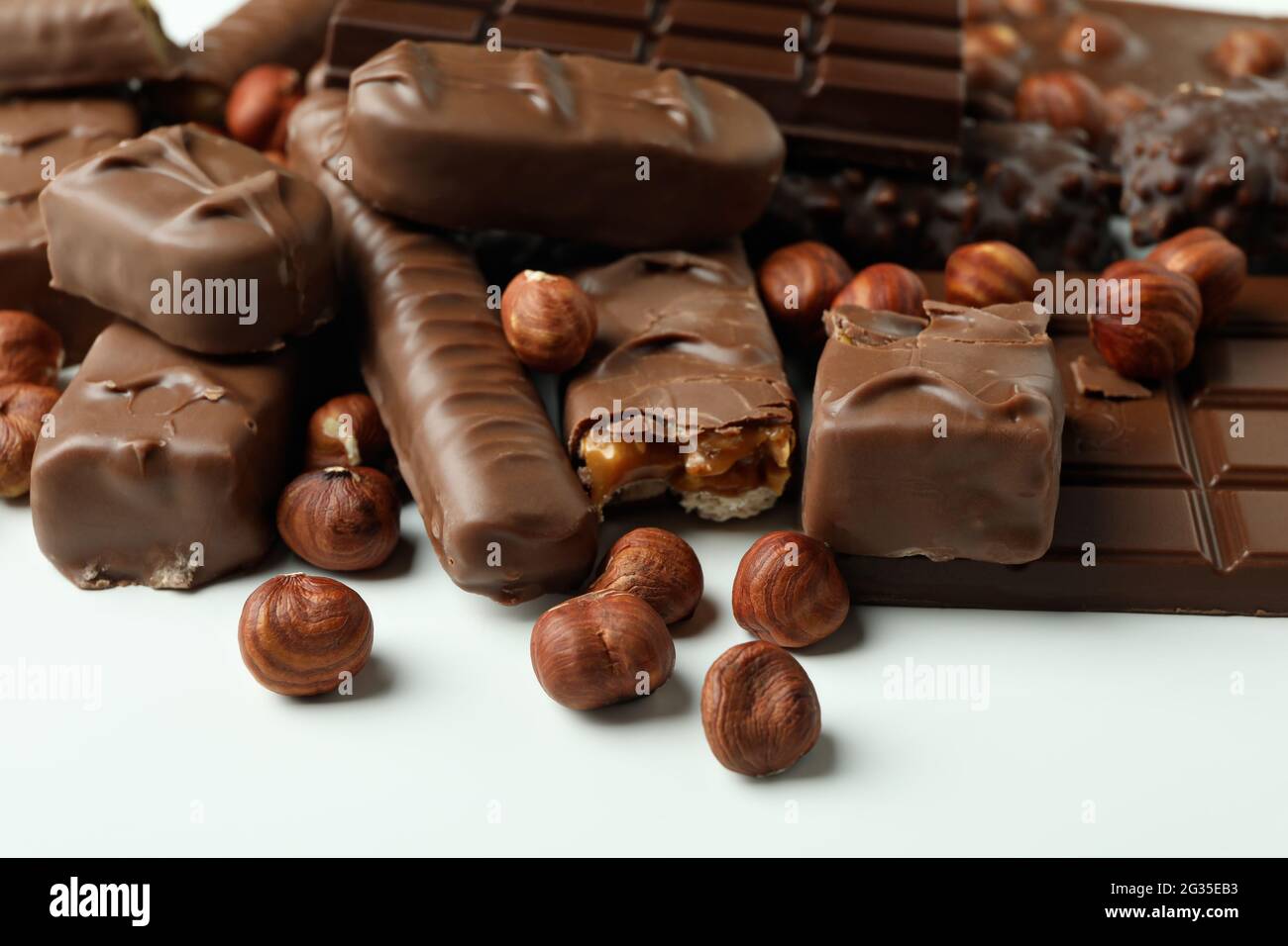 Different tasty candy bars on white background Stock Photo - Alamy