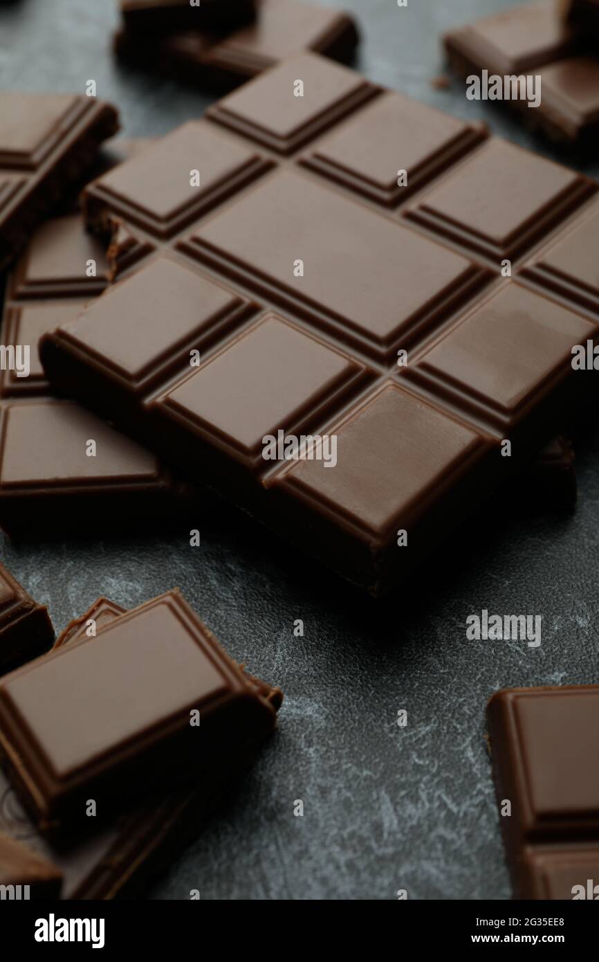 Tasty chocolate bars on black smokey background Stock Photo - Alamy