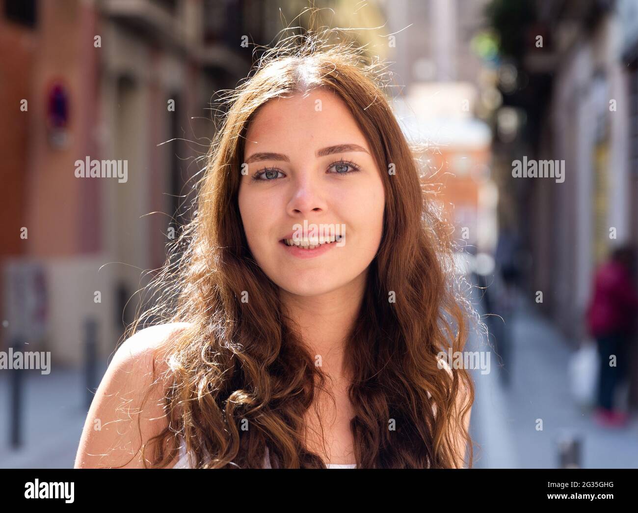 Cheerful attractive female walking on street outdoor Stock Photo - Alamy