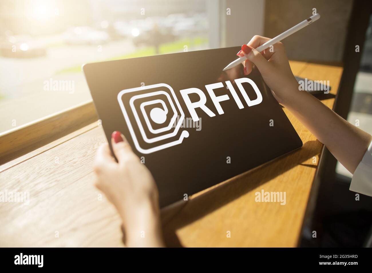 RFID Radio frequency identification technology concept on device screen ...