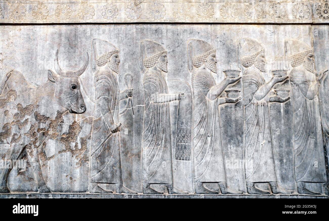 Ancient wall with bas-relief with assyrian foreign ambassadors with ...